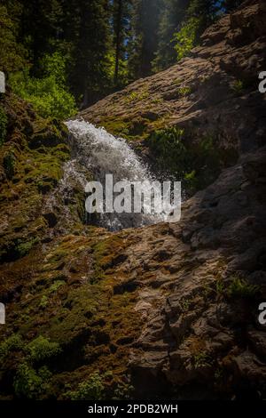 A waterfall dropping into hole in the rocks Stock Photo - Alamy
