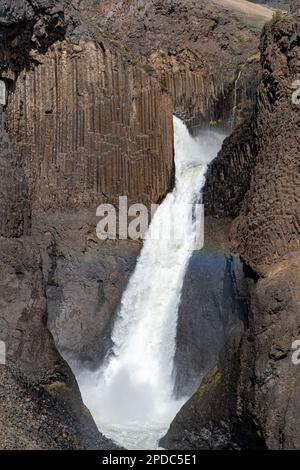Waterfall Litlanesfoss surrounded by basalt columns in eastern Iceland ...