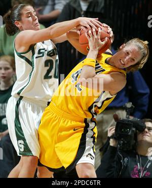 Michigan State's Lindsay Bowen, left, drives to the basket as she is ...