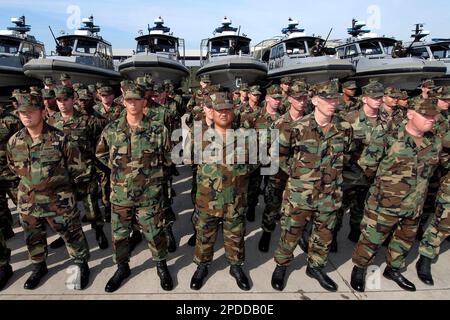 US Navy Navy Coastal Warfare Squadron Four (NCWS-4) Sailors stand at ...