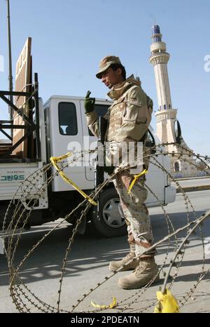 Iraqi soldiers set up a makeshift checkpoint in front of the Sunni al ...