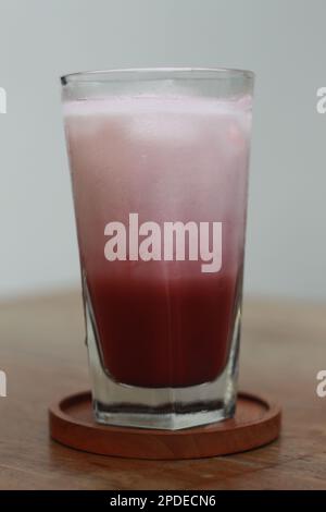 a glass of red velvet latte served cold on the table Stock Photo - Alamy