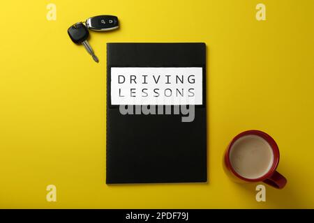Flat lay composition with workbook for driving lessons and road signs ...