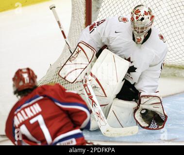Team Canada's Justin Pogge makes a glove-save in the first period ...