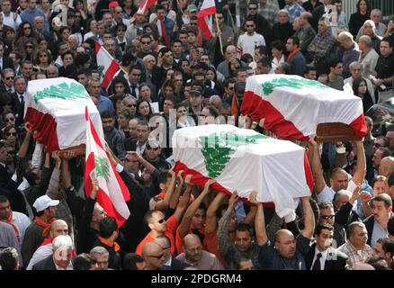 Lebanese mourners carry the coffin of slain anti-Syrian journalist and ...