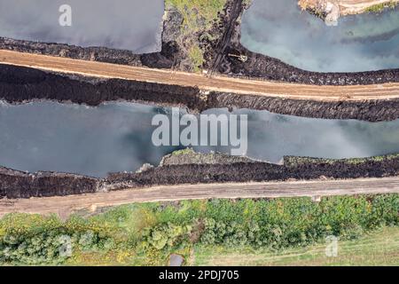 land improvement and reclamation. excavator digging the turf in swampy ...
