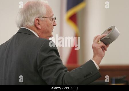 Prosecutor Joe Shannon holds up the duct tape mask that killed Laura ...