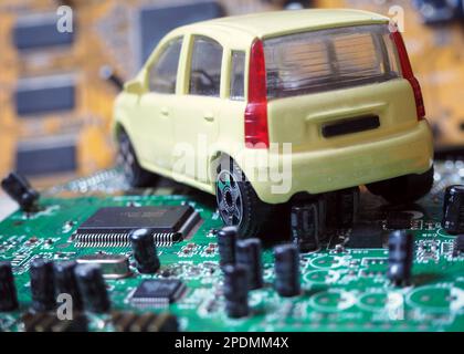 Toy cars on electronic board and microchip. Conceptual image for ...