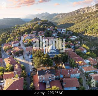Aerial view of secluded cottage in the woods among green trees. Cabin ...