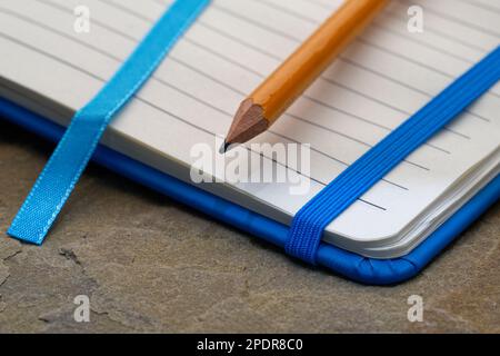 A lined notebook with a pencil. Ready to take notes, sketch ideas and ...