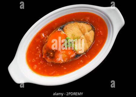 Vietnamese stewed sapa fish in red sauce isolated on black bacground ...