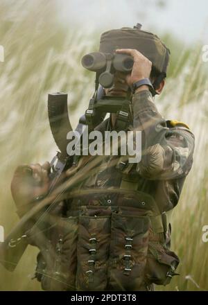 An Indian Army Soldier looks through a 84 MM RL Gun at a Forward Post ...