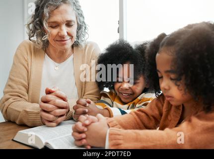 Family, kids and praying with bible books in support, faith or ...