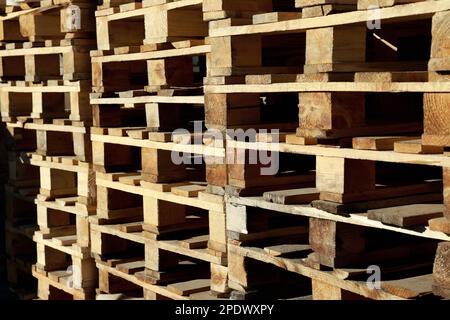 Many empty wooden pallets stacked in warehouse Stock Photo - Alamy