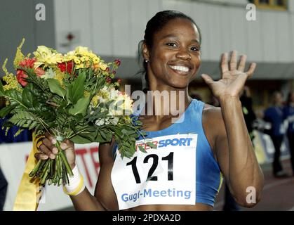 Chandra Sturrup, from Bahamas, waves to the crowd after winning the 100 ...