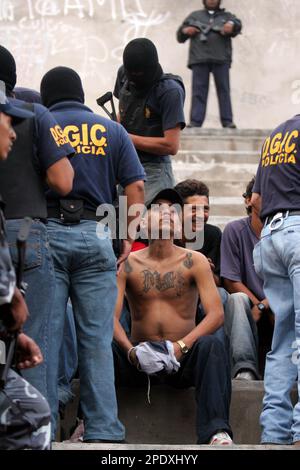 A member of the Mara Salvatrucha gang (MS-13) shows off his gang ...