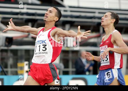 Bahrain's Rashid Ramzi reacts as he crosses the line ahead of Russia's ...