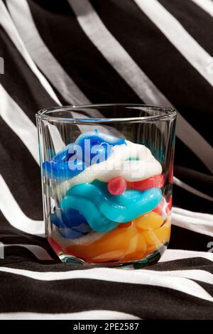 Various toothpaste of many colors squeezed into a cup with a spoon ...