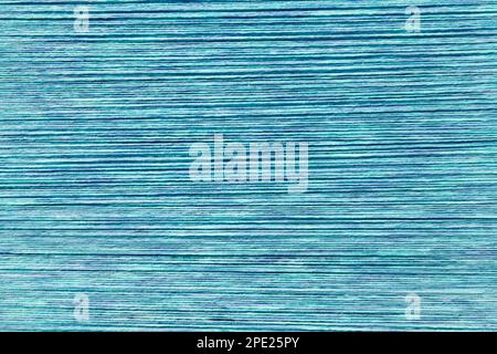Sky blue yarn threads stretched on a loom abstract background. Turquois ...