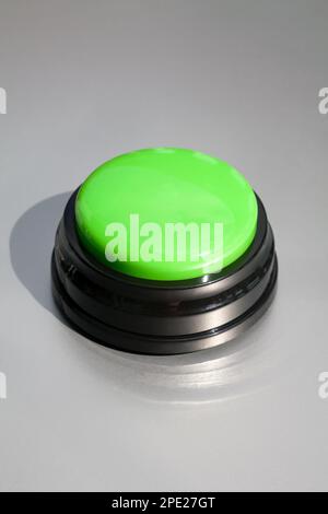 Big green buzzer for answers in a game show isolated on gray. Wireless ...