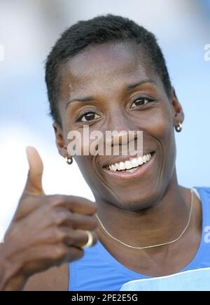 Fiona May of Italy celebrates her gold medal in the long jump with ...