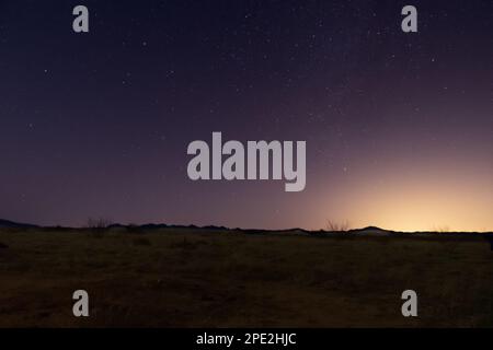 The starry night sky appearing at the end of daylight over the ...