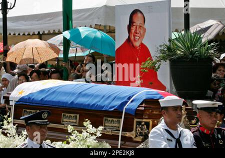 The flag-draped coffin of Filipino Catholic Cardinal Jaime Sin is given ...