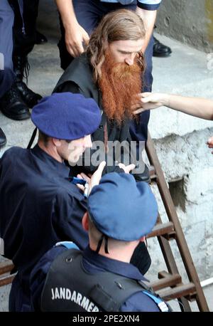 Daniel Petre Corogeanu, center, the orthodox monk believed to have led ...