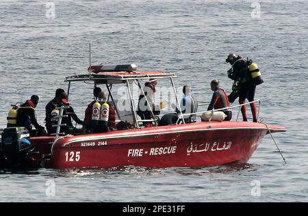 Lebanese civil defense and U.N. investigators transport their diving ...