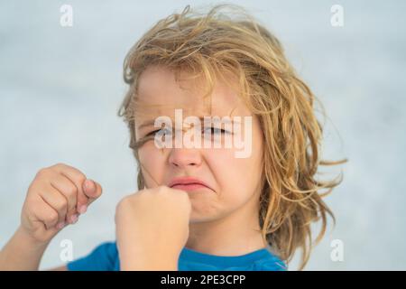 Kid boy with angry expression. Angry hateful little aggression boy, child furious. Angry rage ...