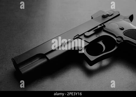 Black metal gun on stone table, top view Stock Photo - Alamy