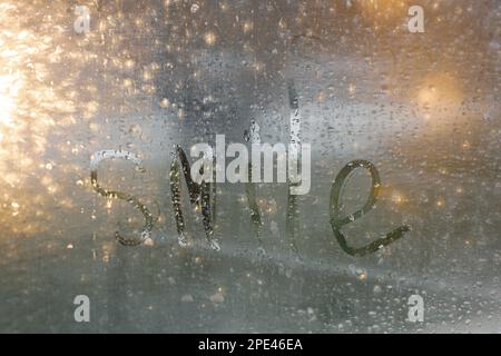 Word SMILE written on foggy window. Rainy weather Stock Photo - Alamy
