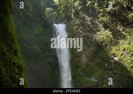 An imposing waterfall in an enclosed valley in Banaue in the ...