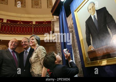 Senator George Mitchell and his wife Heather MacLachlan look at a newly unveiled bust of himself ...