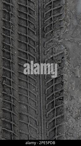 Traces of car tire tread in the ground. Pattern. Dark abstract ...