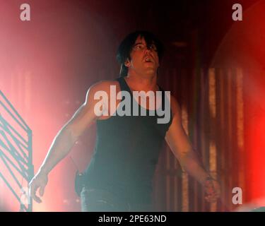 Trent Reznor, lead singer of Nine Inch Nails, performs covered in mud ...