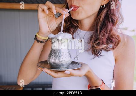 Girl drinks a traditional Kazakh and Asian fermented milk drink from ...