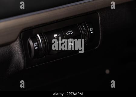 Hand operating ESP (electronic stability program) control close up view ...