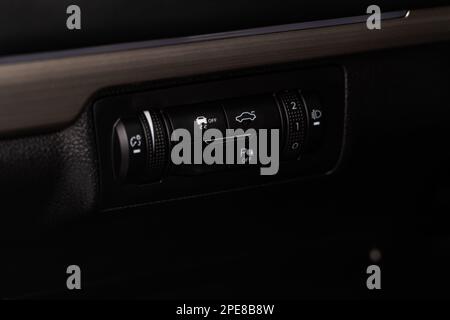 Hand operating ESP (electronic stability program) control close up view ...