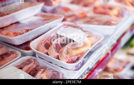 Packaged mutton meat laid out on display shelves of butcher store Stock ...