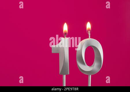 Candle number 4 - Birthday in rhodamine red background Stock Photo - Alamy