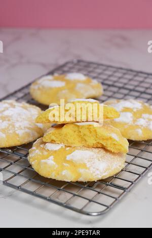 A closeup of tasty cookies with sugar powder on a wooden table with a ...