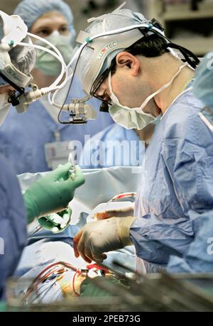 surgeon works in the operating room by the light of a lamp Stock Photo ...