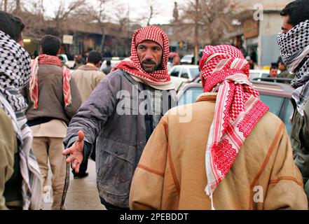 Arab construction workers brave the winter cold as they stand on the ...