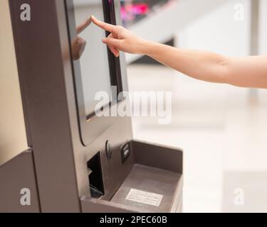 Faceless woman using touchscreen ATM Stock Photo - Alamy