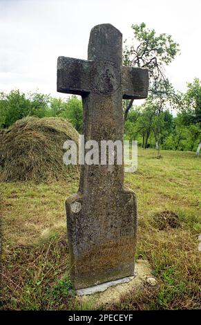 Medieval cross monument with carved inscription. Ancient stone cross ...