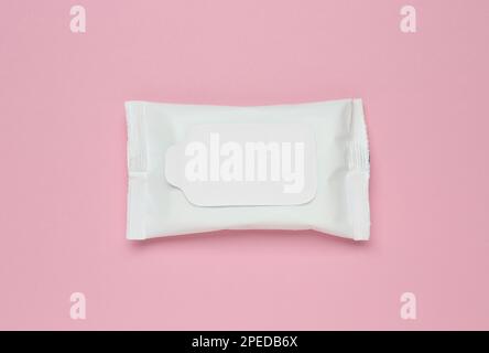 Wet wipes flow pack on light blue background, top view. Space for text ...