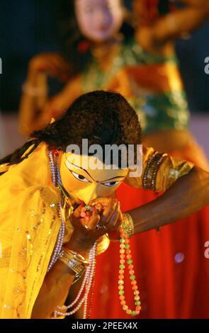 A folk artist from Chhau dance Team poses for a Photo in front of the ...