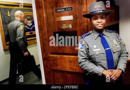 Portrait of a woman Lt Commander in uniform and holding her hat under ...