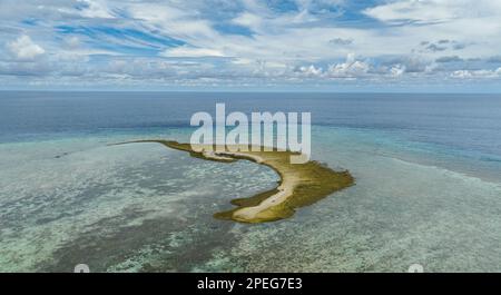 Aerial view of Mataking island on a coral reef or atoll with a sandy ...